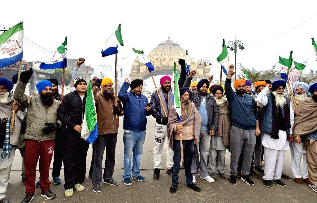Farmers block a road during the statewide ‘bandh’ called as part their ...