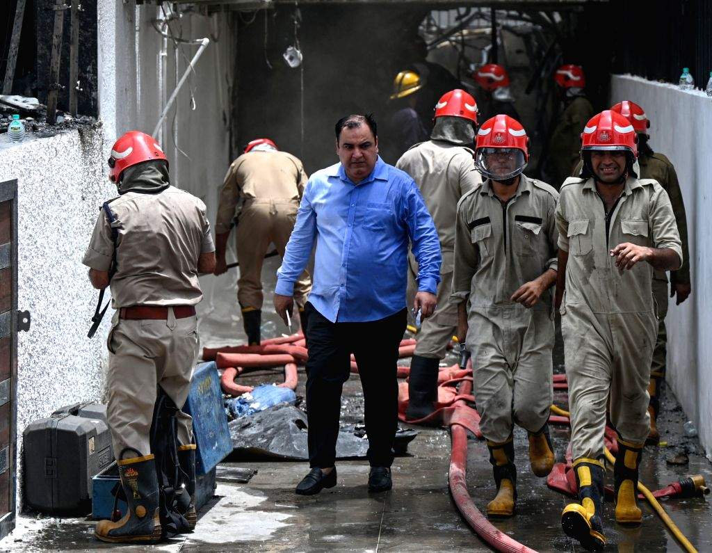 Firefighters at the incident site where a fire broke out at an eye ...