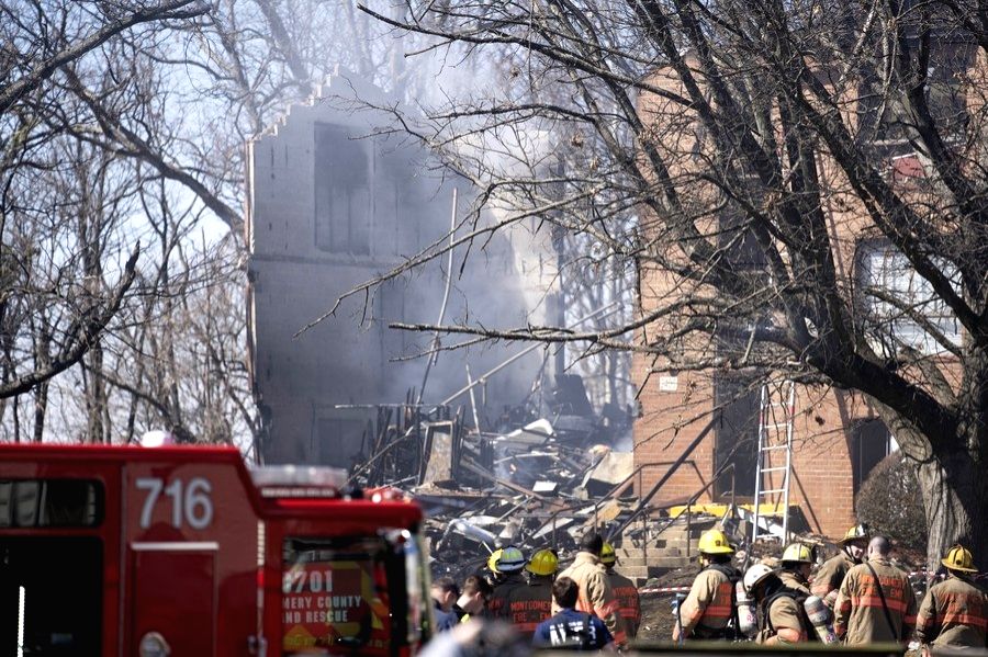 Firefighters work at the scene of an explosion in Silver Spring