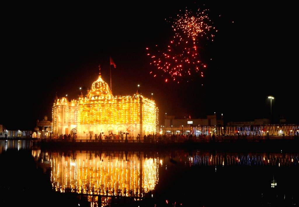 Fireworks adorn the sky above the Durgiana Temple on the occasion of ...