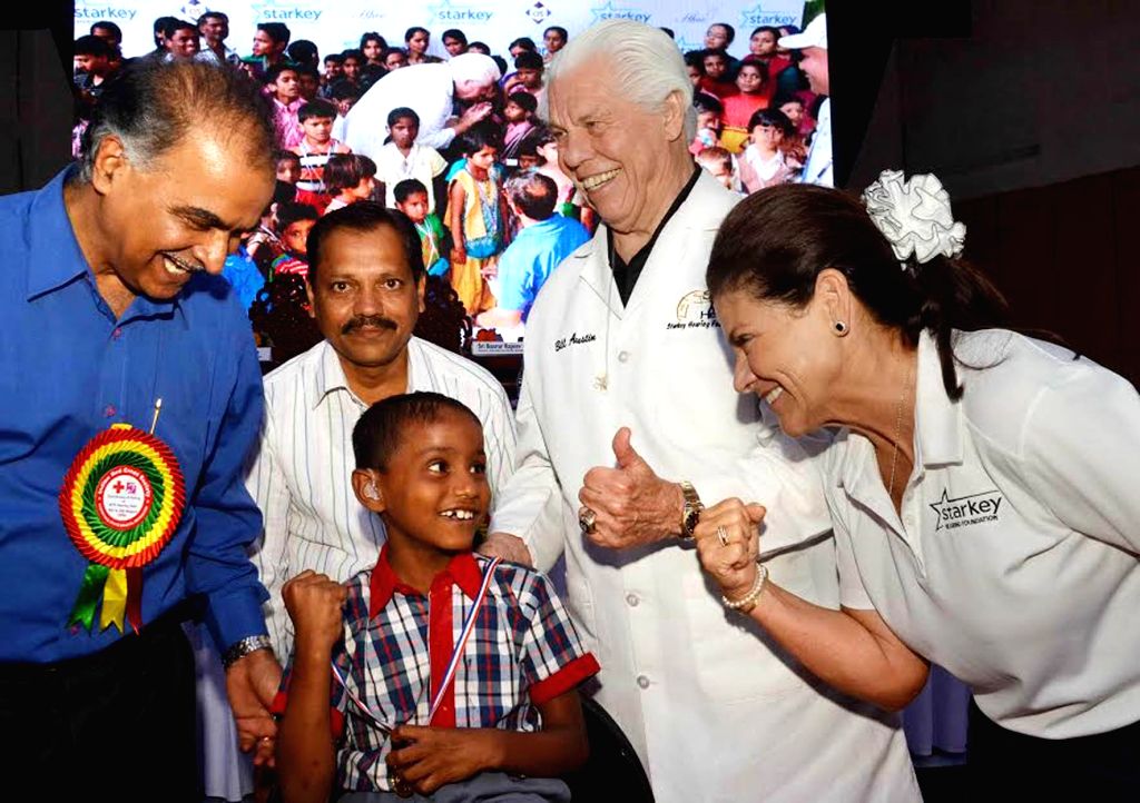 William F Austin distribute BTE hearing Aids to deaf children