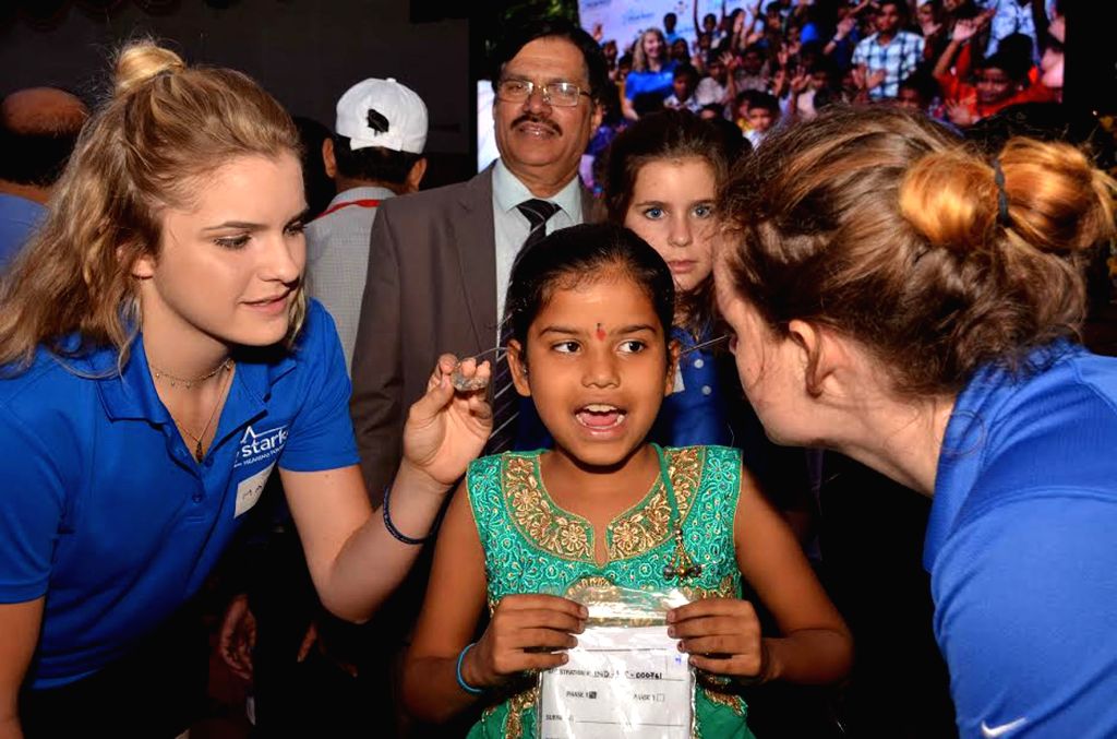 William F Austin distribute BTE hearing Aids to deaf children