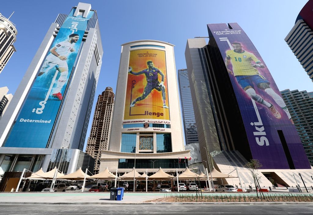 :Doha :Giant photos of main players from each nation are hung on the ...