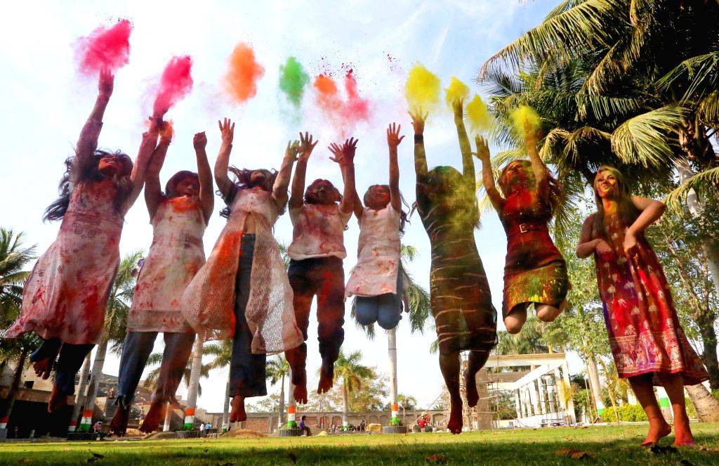 Girls smeared with Gulal (colour powder) during Holi celebrations
