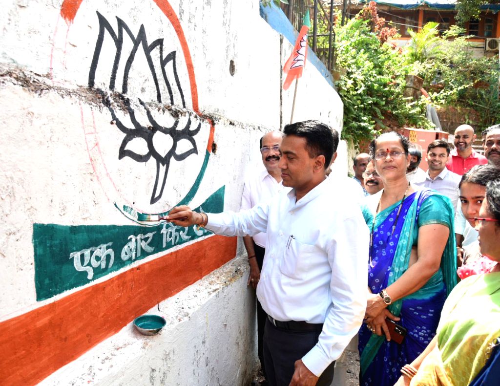 Goa CM and BJP leader Dr Pramod Sawant paints a lotus on the wall