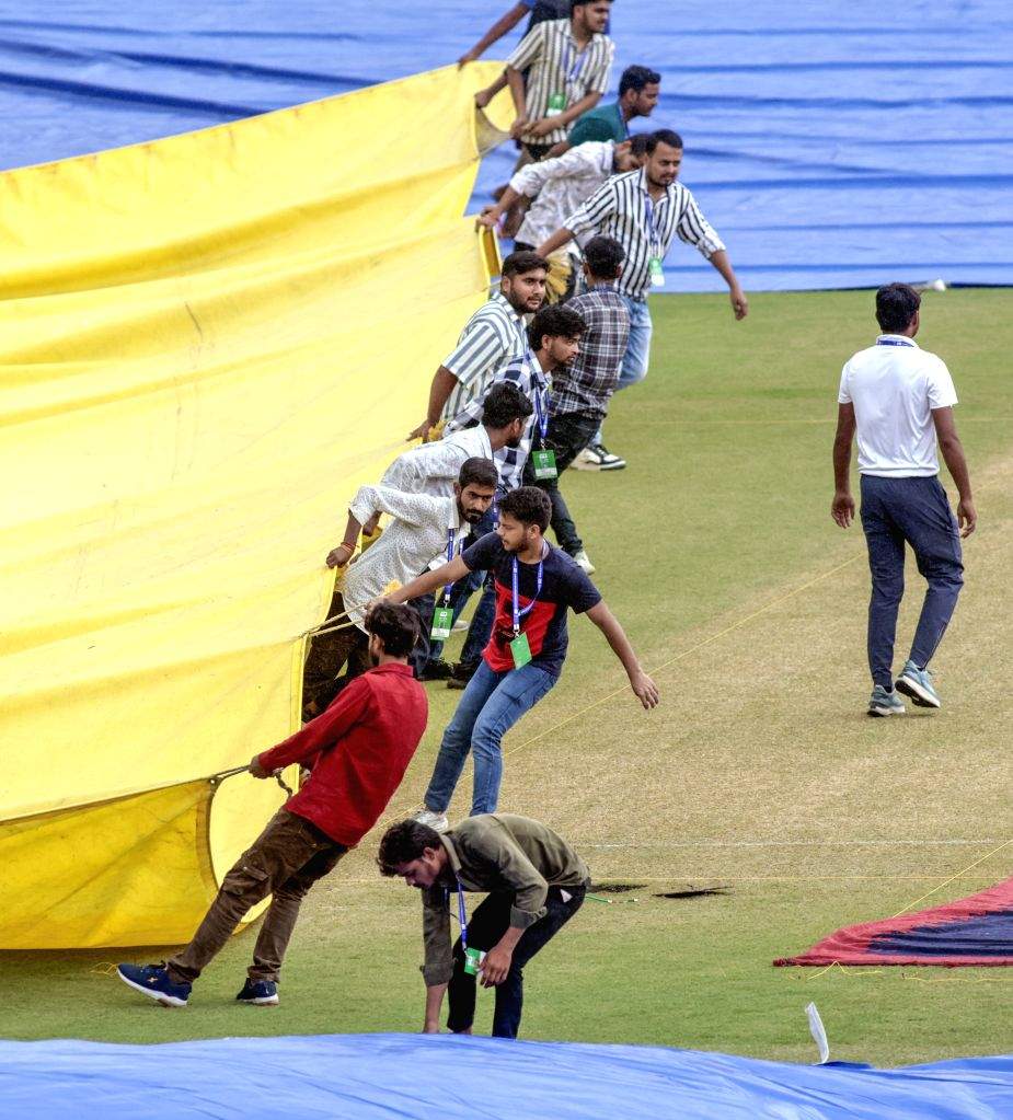 Groundsmen pull covers onto the field ahead of the second Test cricket ...