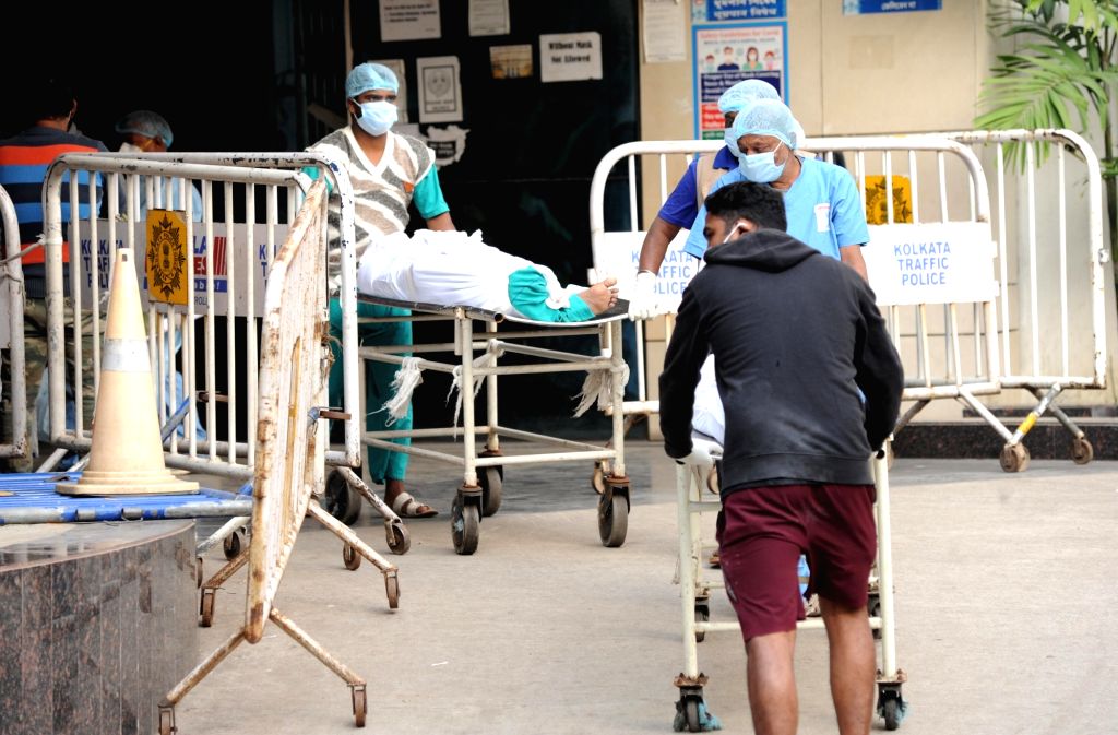 Health workers carrying dead bodies of COVID patients