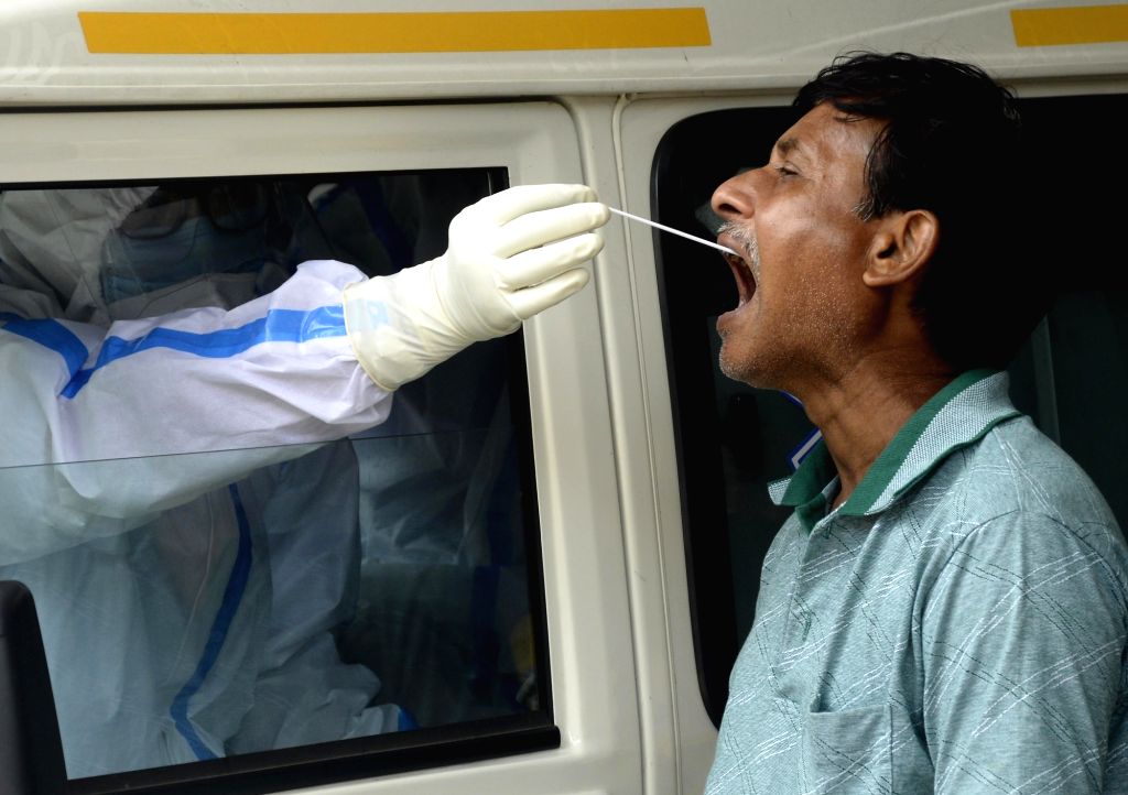 Health workers collect swab samples for COVID-19 testing