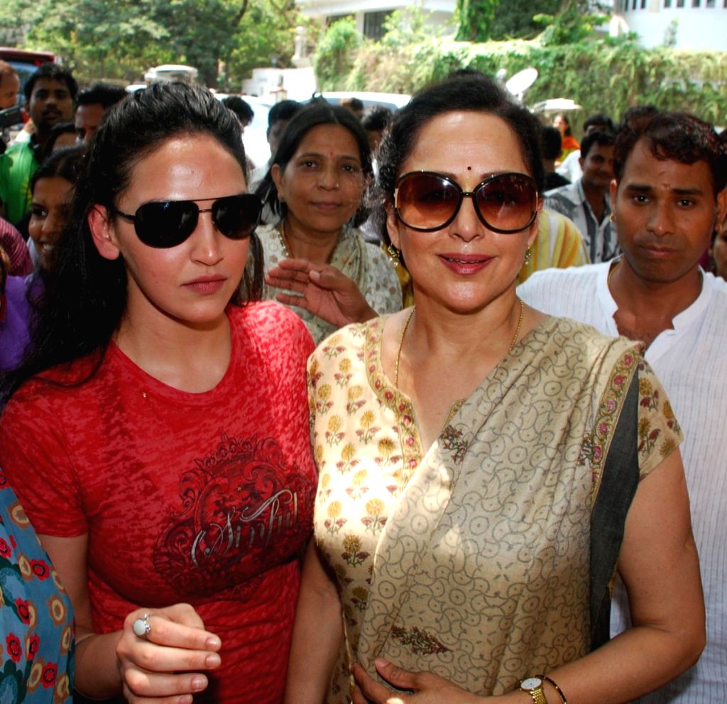 Hema Malini with her daughter Isha Deol after casting their votes in ...