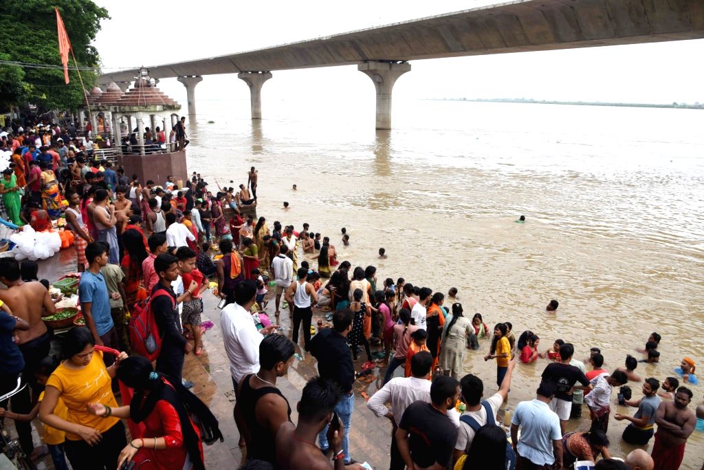 Hindu devotees take holy dip in the Ganga river during the Third 'Somwar