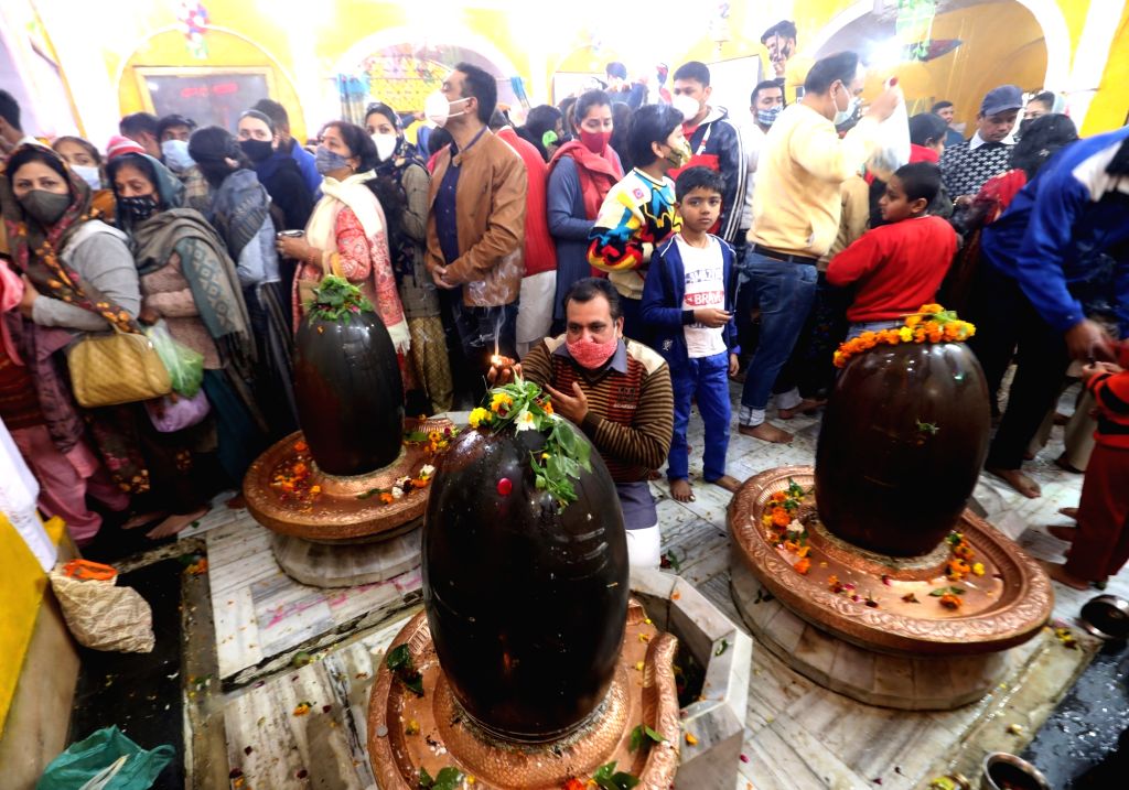 Hindu devotees worship Shivling, a representation of Hindu god Shiva ...