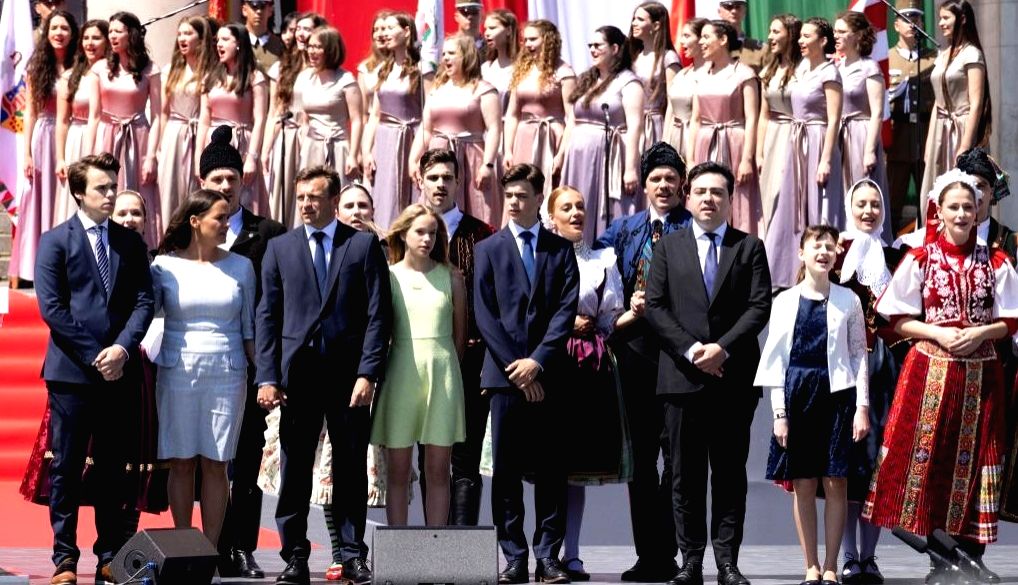 Hungarian President Katalin Novak (front, 2nd L) sings with her family ...