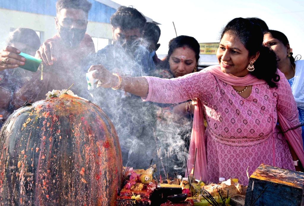 Devotees worship a Shivling.