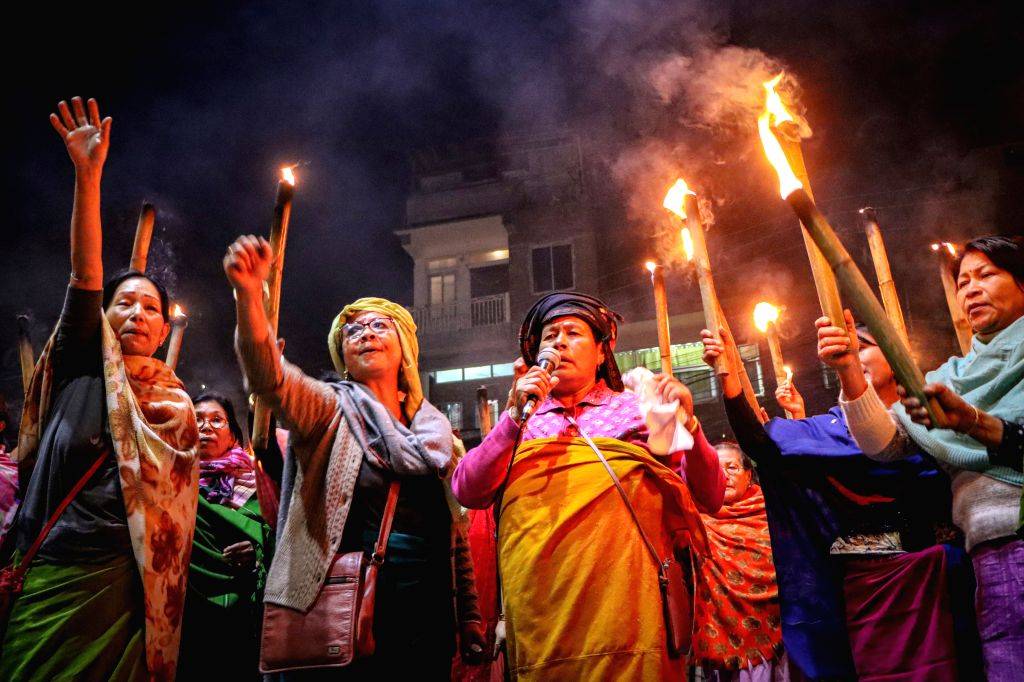 Imphal West: Members of Meira Paibi hold torches and raise slogans at ...