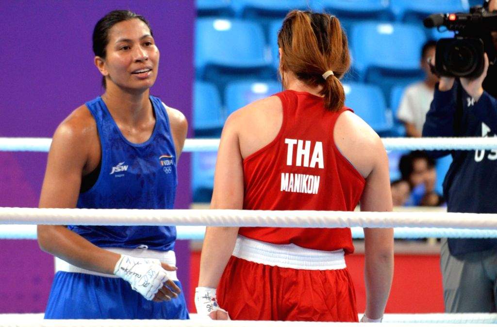 India's Lovlina Borgohain (blue) and Thailand's Baison Manikon during ...