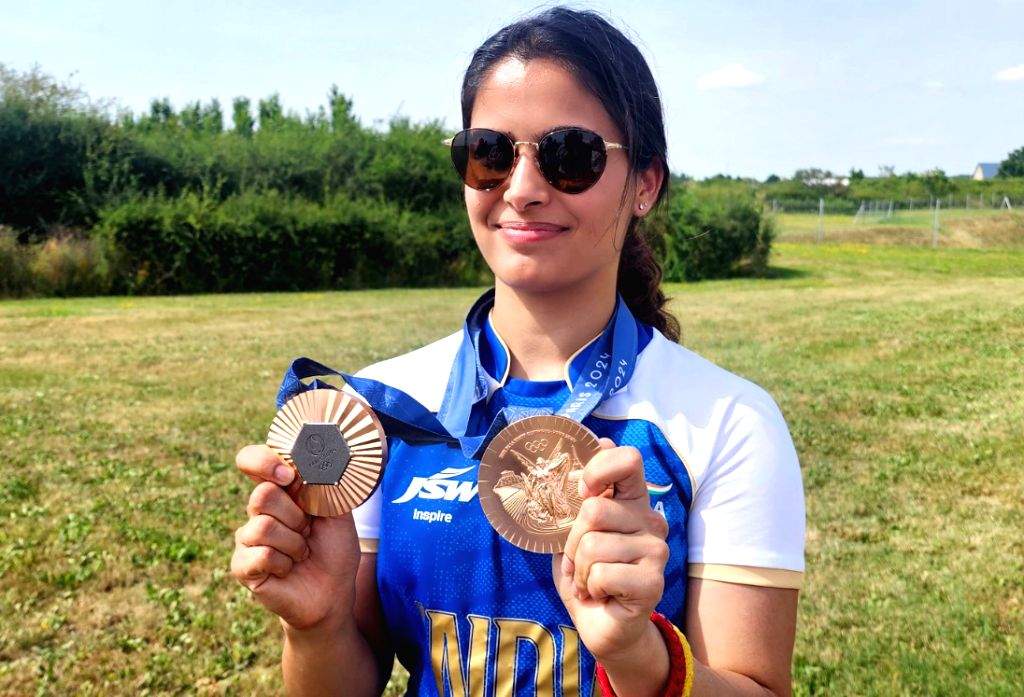India's Manu Bhaker poses with her two bronze medals won at the Paris ...