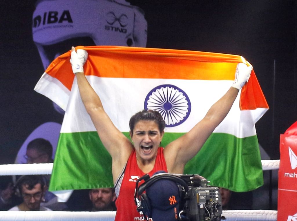 India's Saweety Boora (Red) (81kg) in a action vs Wang Lina of China in ...