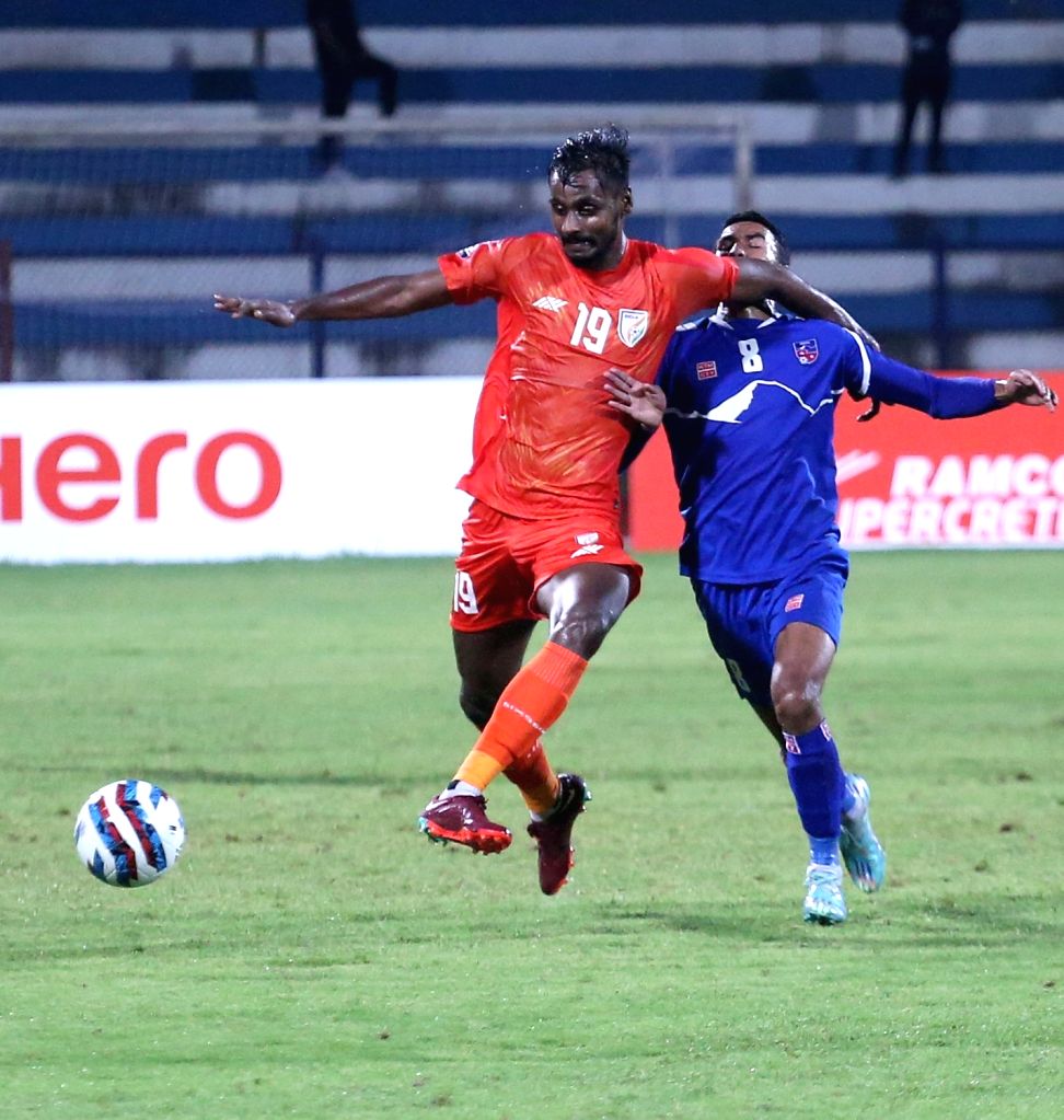 Indian's Rohit Kumar (Orange) in action against Nepal