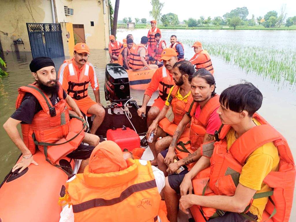 NDRF teams carry out rescue and evacuation operations in flood-affected ...