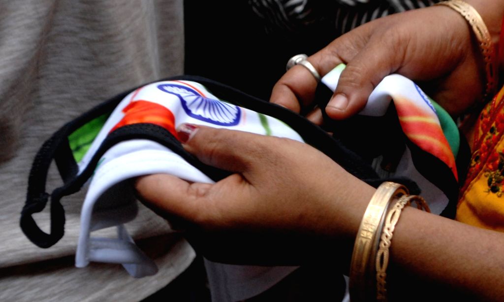 People wear tricolored masks to mark 74th Independence Day