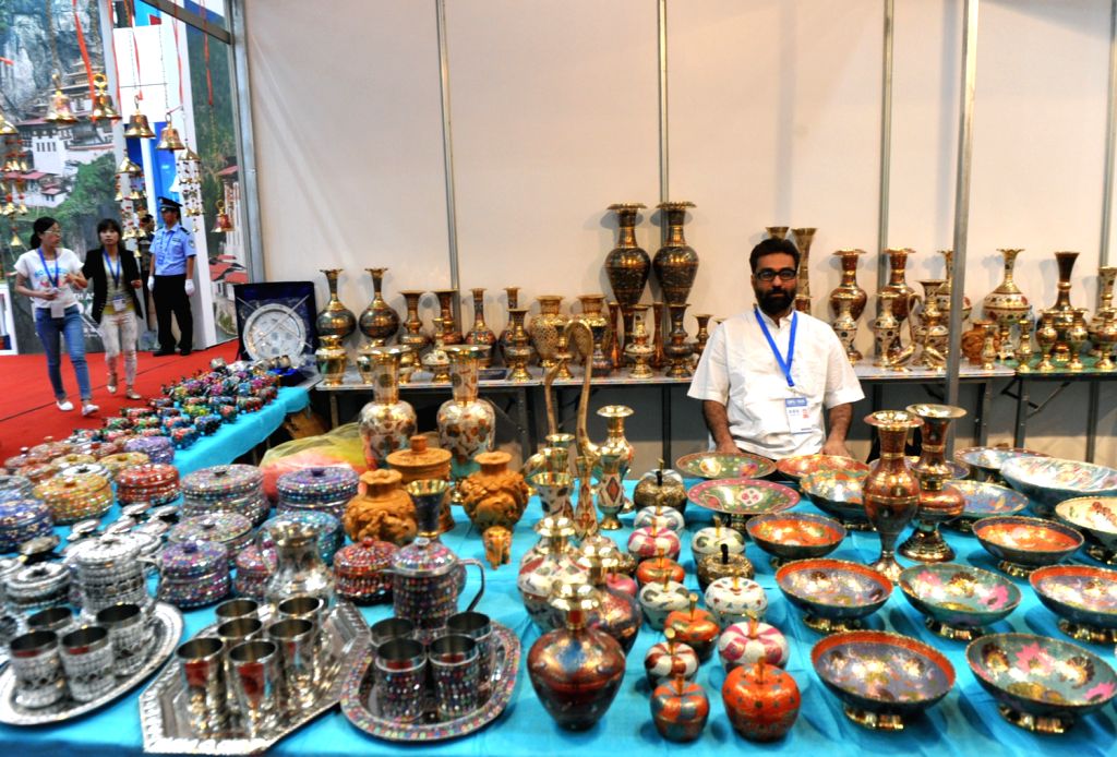 An Indian exhibitor arranges products at the first China-South Asia ...