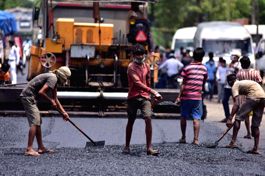 Labourers working at a road construction site during relaxed lockdown