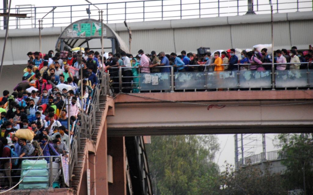 Large numbers of migrants at Kaushambi bus stand to board buses for ...