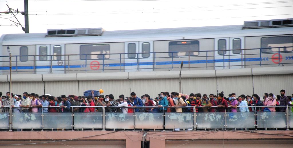 Large numbers of migrants at Kaushambi bus stand to board buses for ...