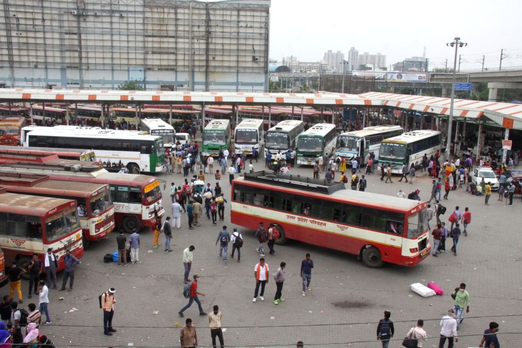 : Large numbers of migrants at Kaushambi bus stand to board buses for ...