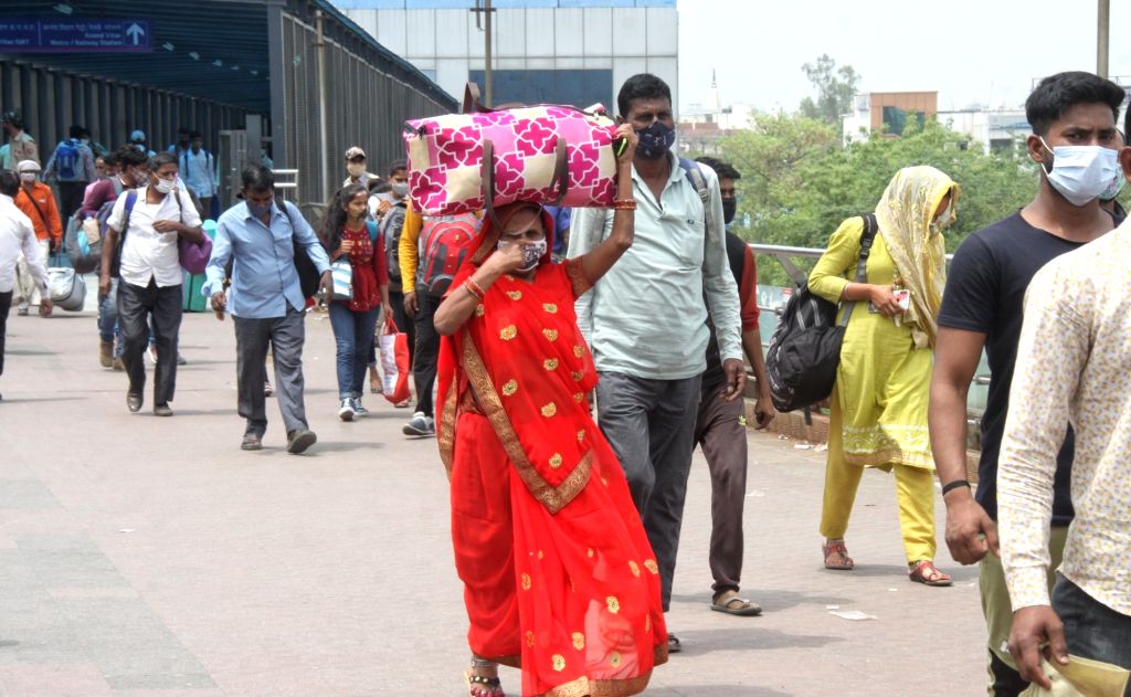 : Large numbers of migrants at Kaushambi bus stand to board buses for ...