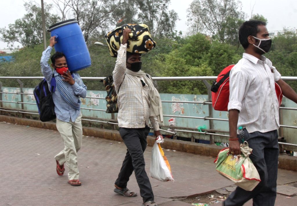 : Large numbers of migrants at Kaushambi bus stand to board buses for ...