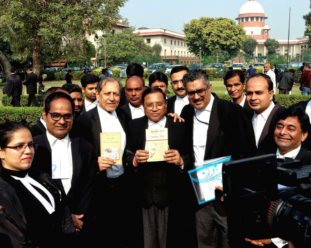 Lawyers react after the Supreme Court upheld the Centre's decision to ...