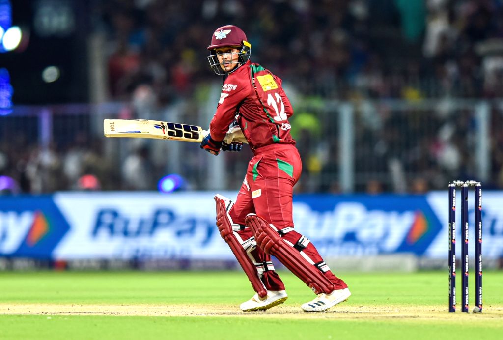 LSG's batsman Quinton de Kock watches the ball after playing a shot