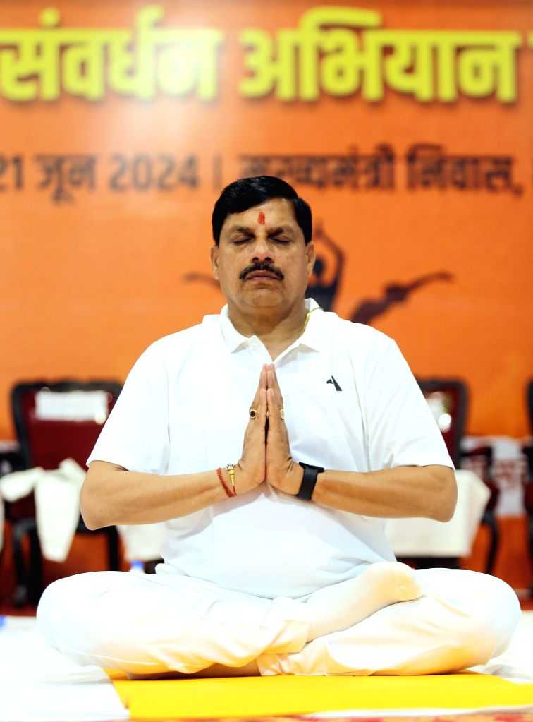 Madhya Pradesh Chief Minister Mohan Yadav performs yoga on the occasion ...