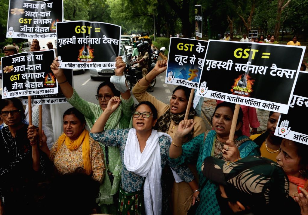 Mahila Congress members stage a protest against inflation and GST hike