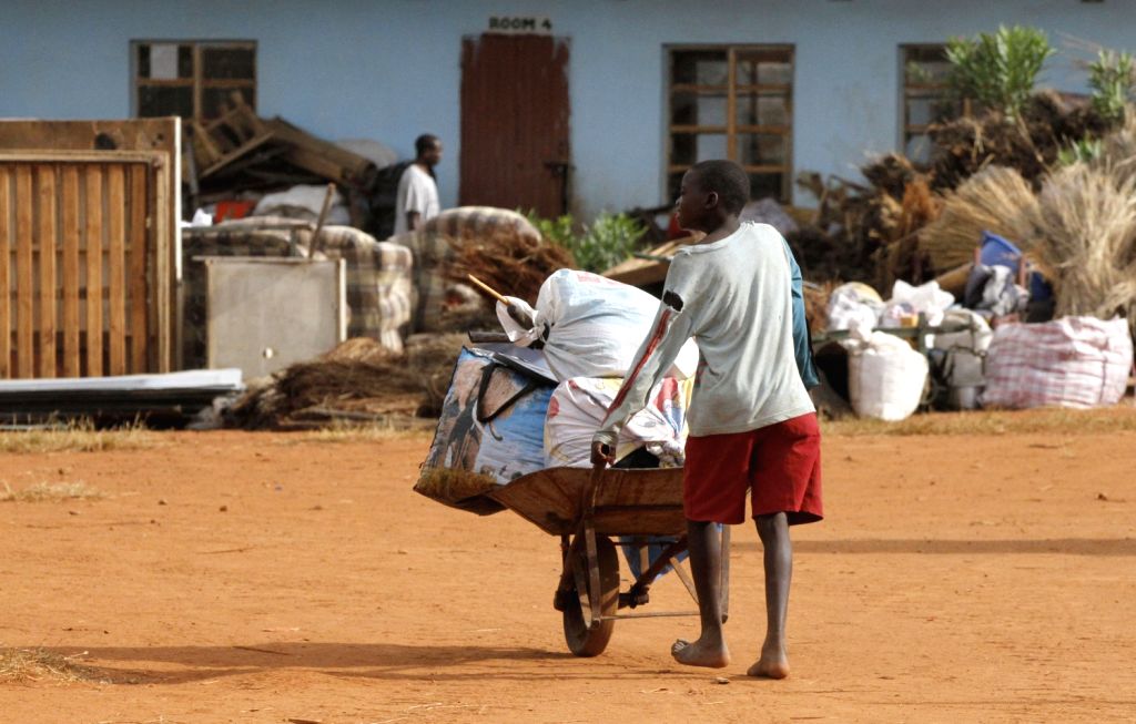 (160214) A man carries a cart at the flood-ravaged Kushinga school in ...