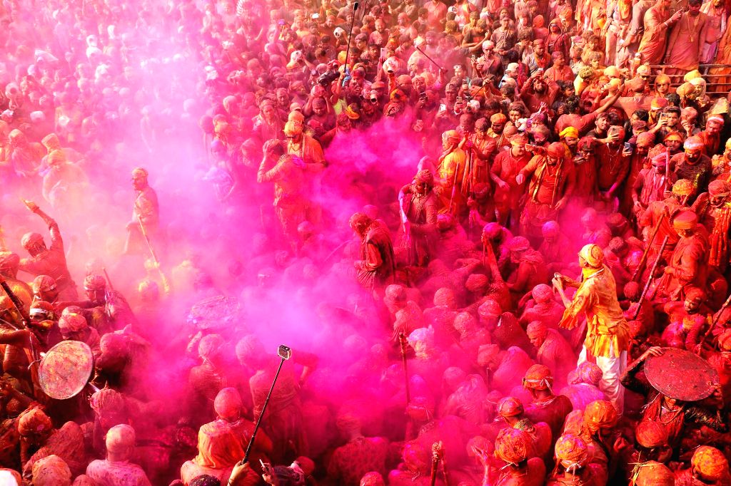 : Mathura: People play Holi at Nand Bhawan Temple.