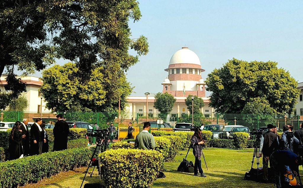 Media persons at the Supreme Court complex on the day of the court's ...