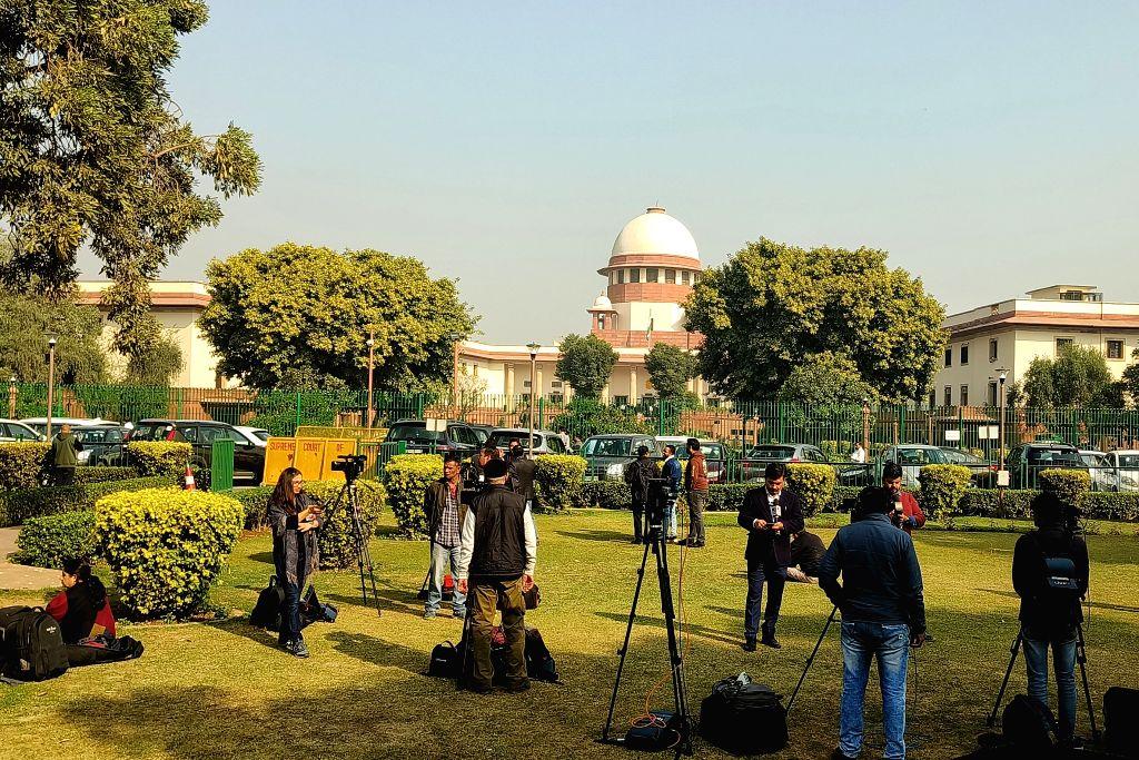 Media persons at the Supreme Court complex on the day of the court's ...