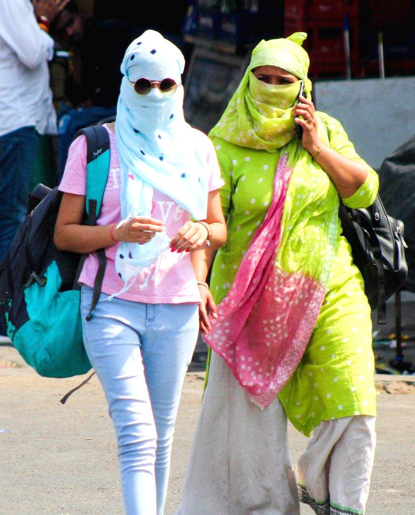 Women cover themselves with scarves on a hot summer day