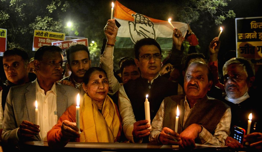 :New Delhi:Members of Delhi Pradesh Congress Committee hold a candle ...
