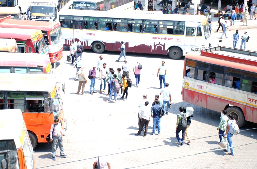 Migrants at Kaushambi bus stand to board buses for their native place ...