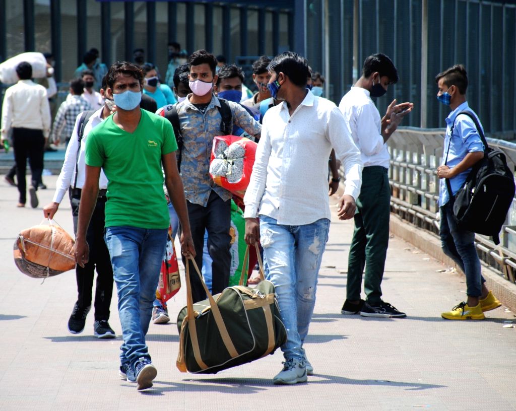 Migrants at Kaushambi bus stand to board buses for their native place ...
