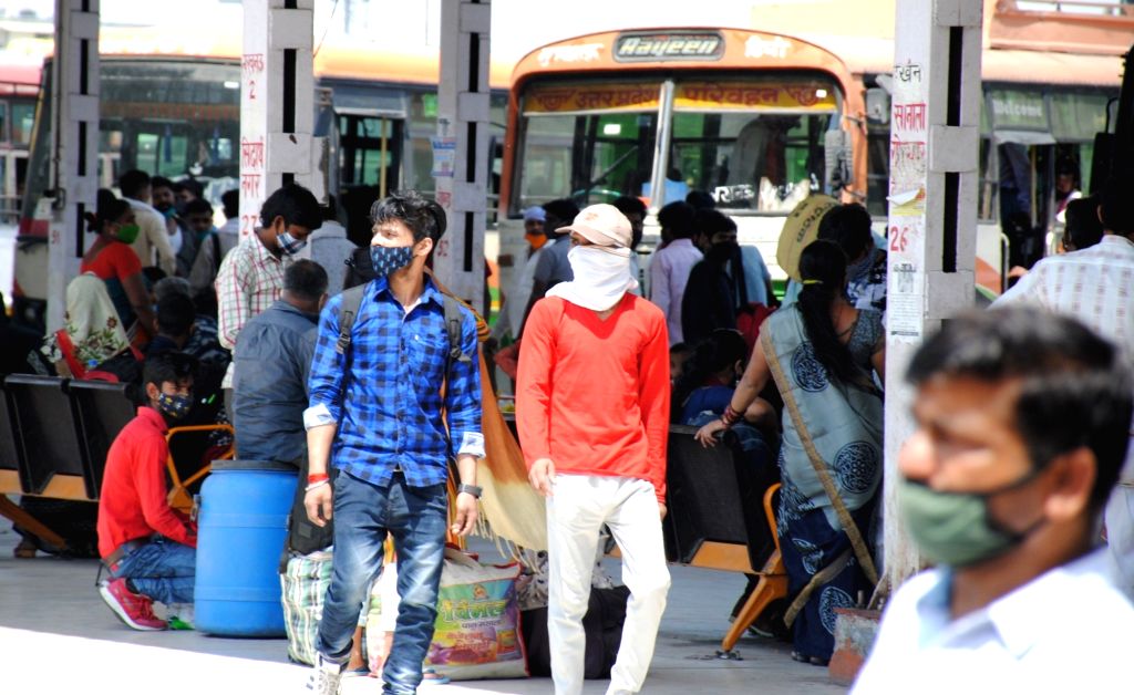 Migrants at Kaushambi bus stand to board buses for their native place ...