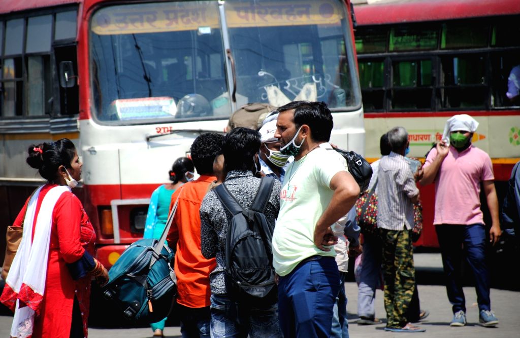 Migrants at Kaushambi bus stand to board buses for their native place ...