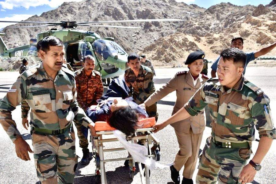 Military personnel assist in the rescue operation after a private bus ...