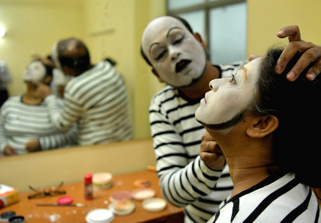 : Agartala :Mime artists preparing themself before their performance.