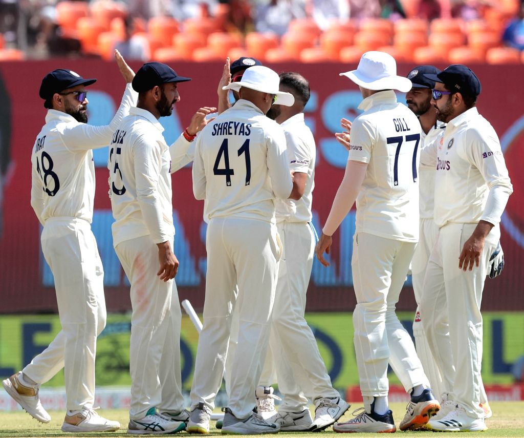 :Ahmedabad:Mohammed Shami, celebrate with his teammates the dismissal ...
