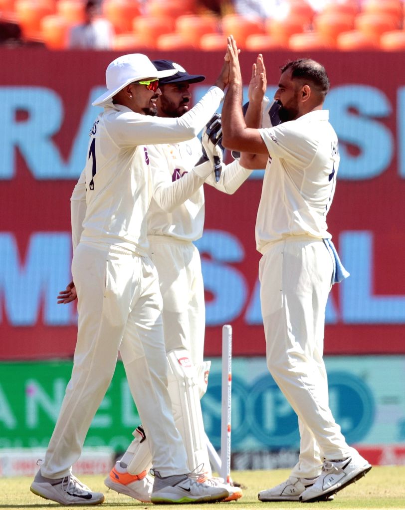 :Ahmedabad:Mohammed Shami, celebrate with his teammates the dismissal ...