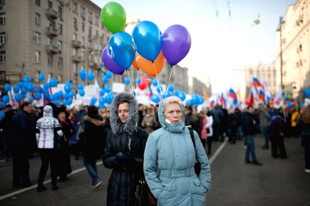 People participate in the parade commemorating the National Unity Day